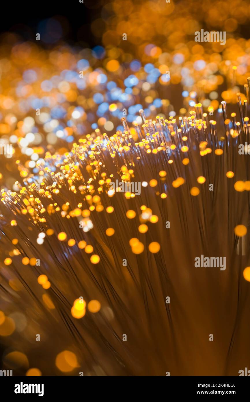 Lit yellow and blue fibre optic strands Stock Photo - Alamy