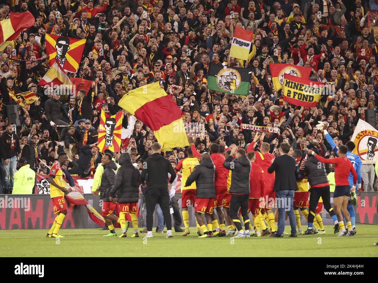 Players of Lens celebrate the victory with their supporters following ...