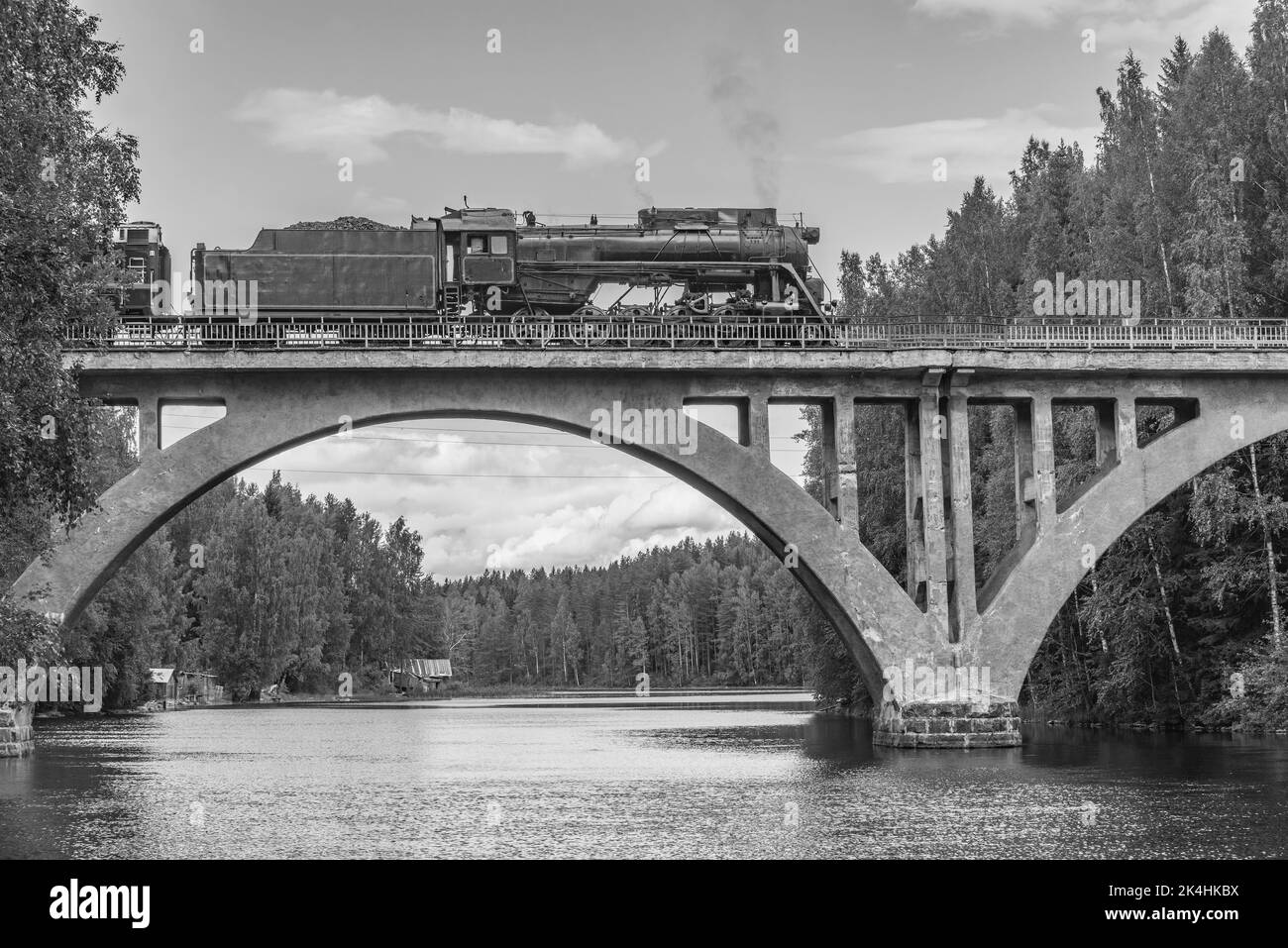 Retro steam train moves above the river at summer day Stock Photo - Alamy