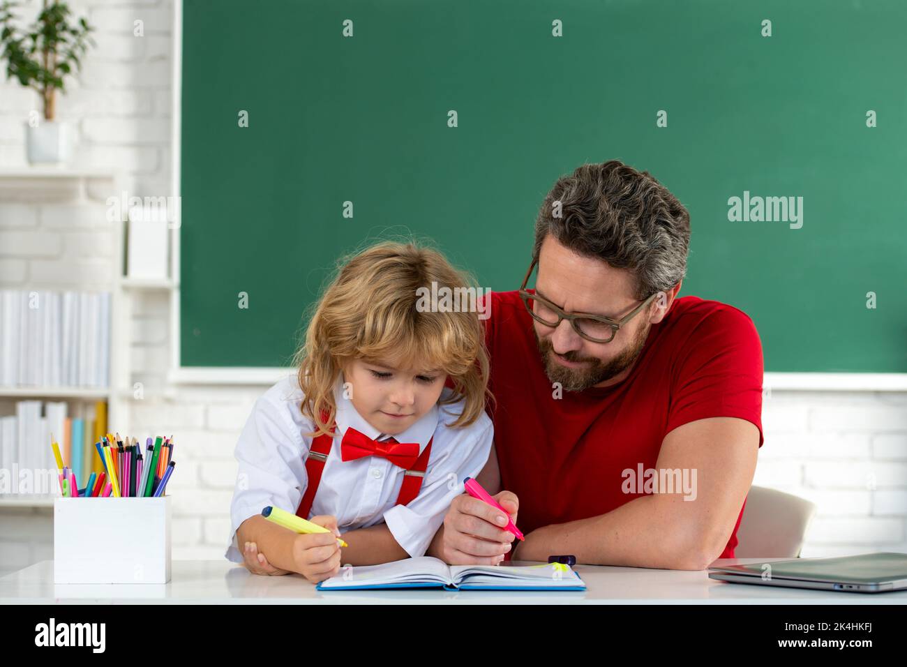 Kid boy learning with teacher. Funny little boy study with father in ...