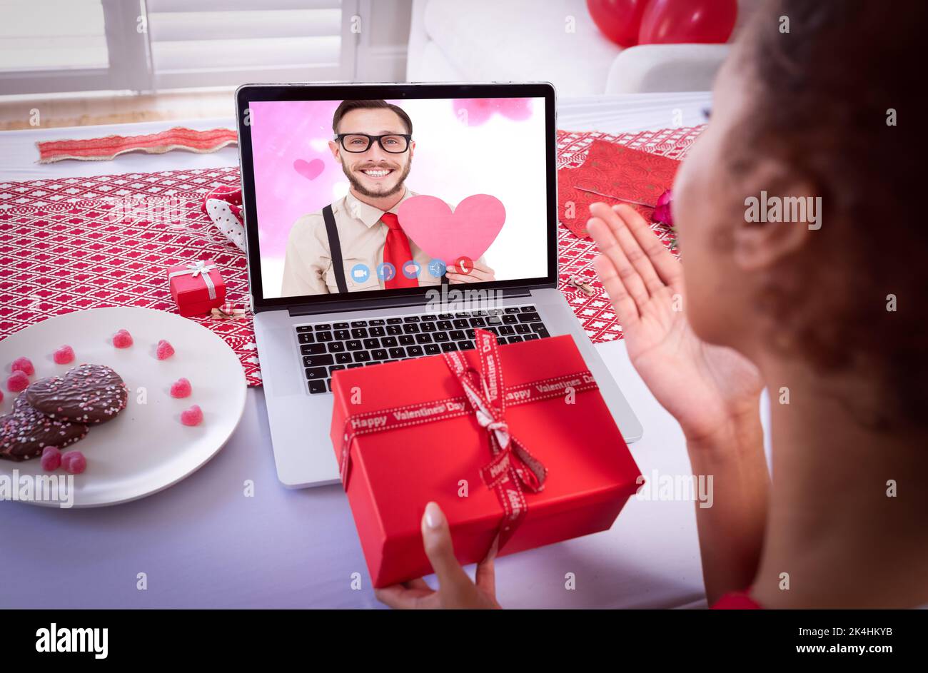 Diverse couple making valentines date video call the woman blowing kiss ...