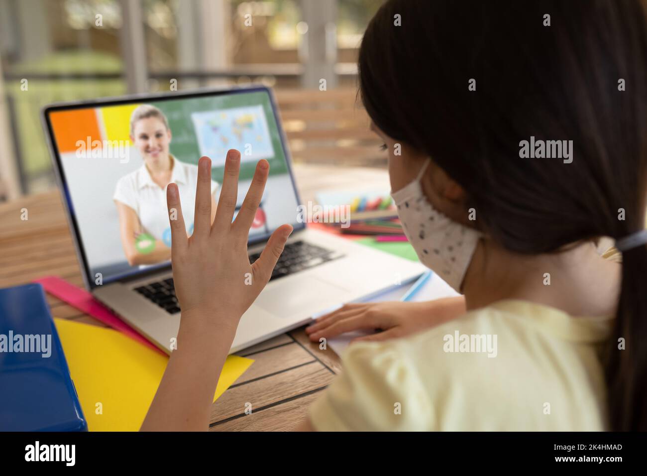 Female student wearing face mask having a video call with female ...