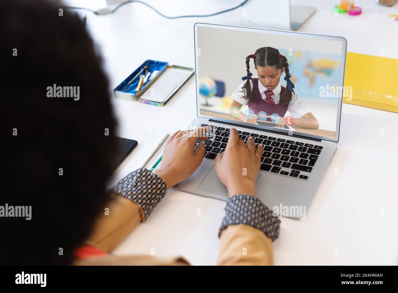 Mid section of female teacher having a video call with female student ...