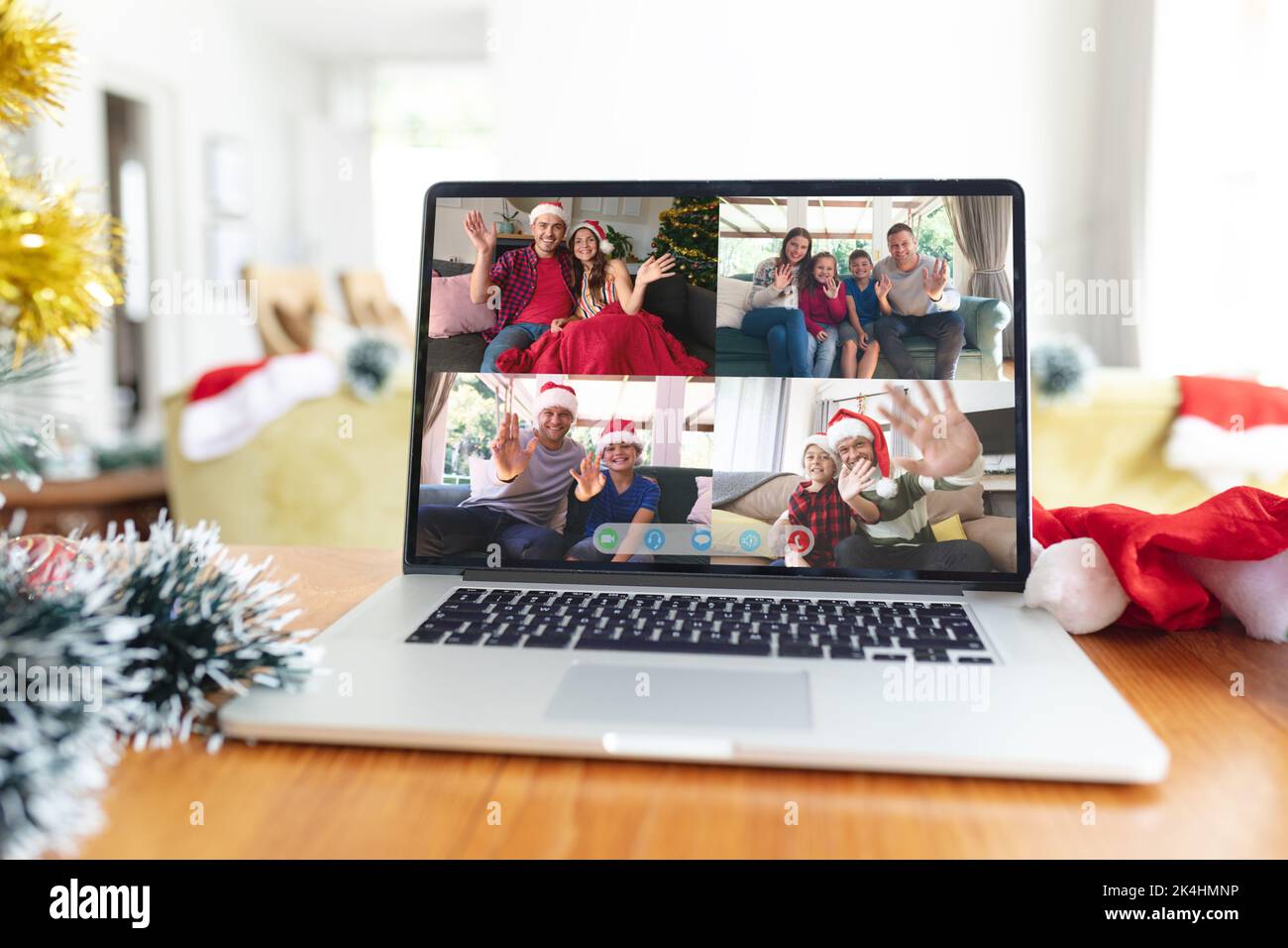 Happy diverse friends and family in christmas santa hats on laptop group video call interface ...