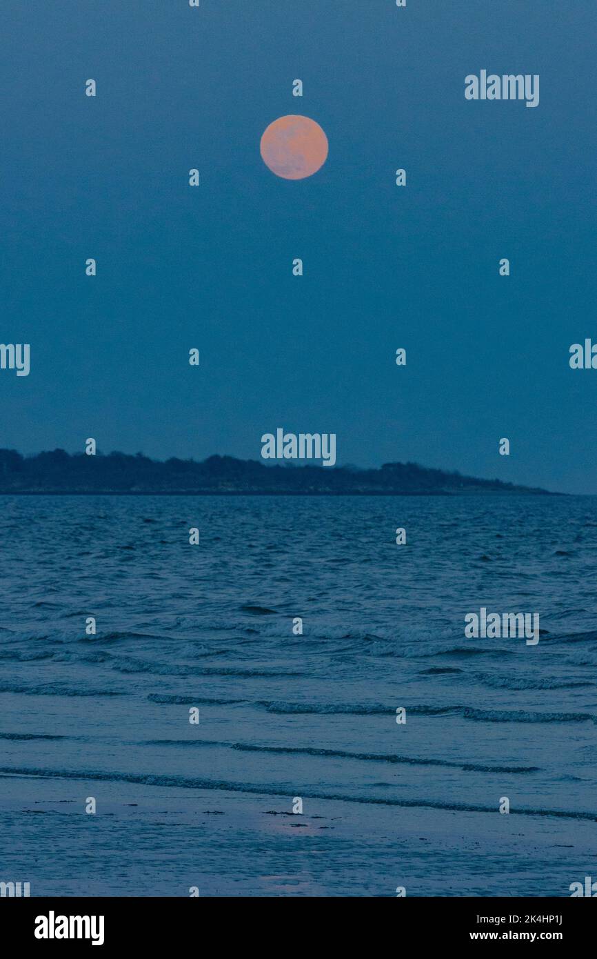 Super Moon Rising Over the Sea with Island in the Background Stock ...