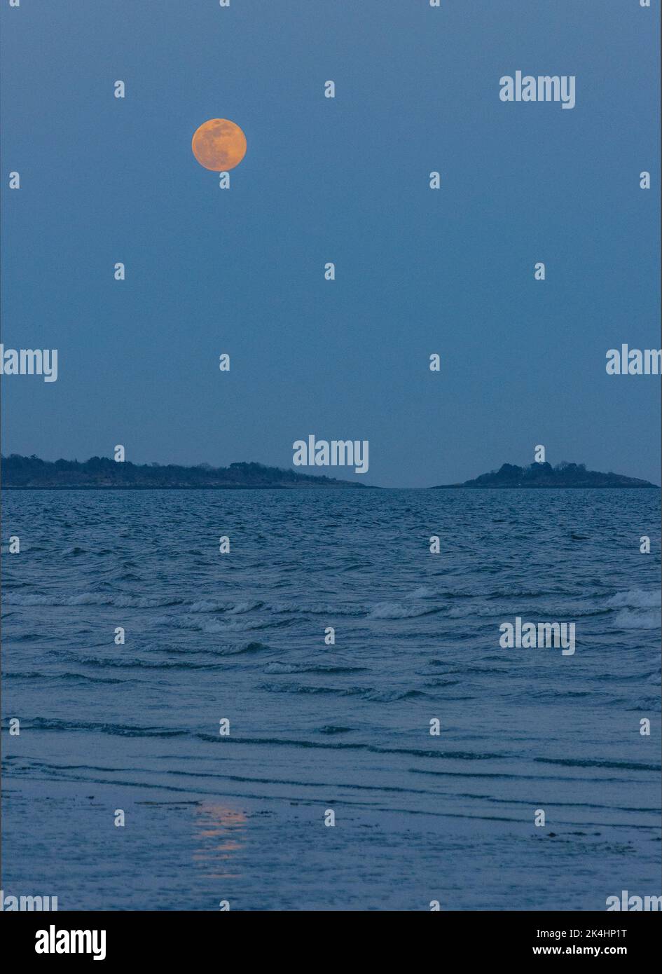 Super Moon Rising Over the Sea with Island in the Background Stock ...