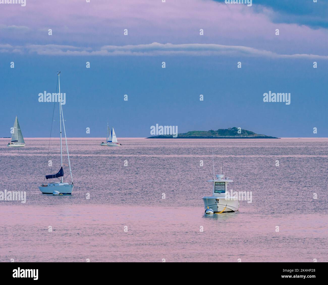 Boats in the Channel with Island in the Background and Pink Clouds ...