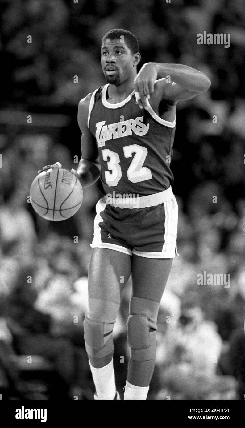 NBA superstar Ervin "Magic" Johnson of the Los Angeles Lakers brings ...