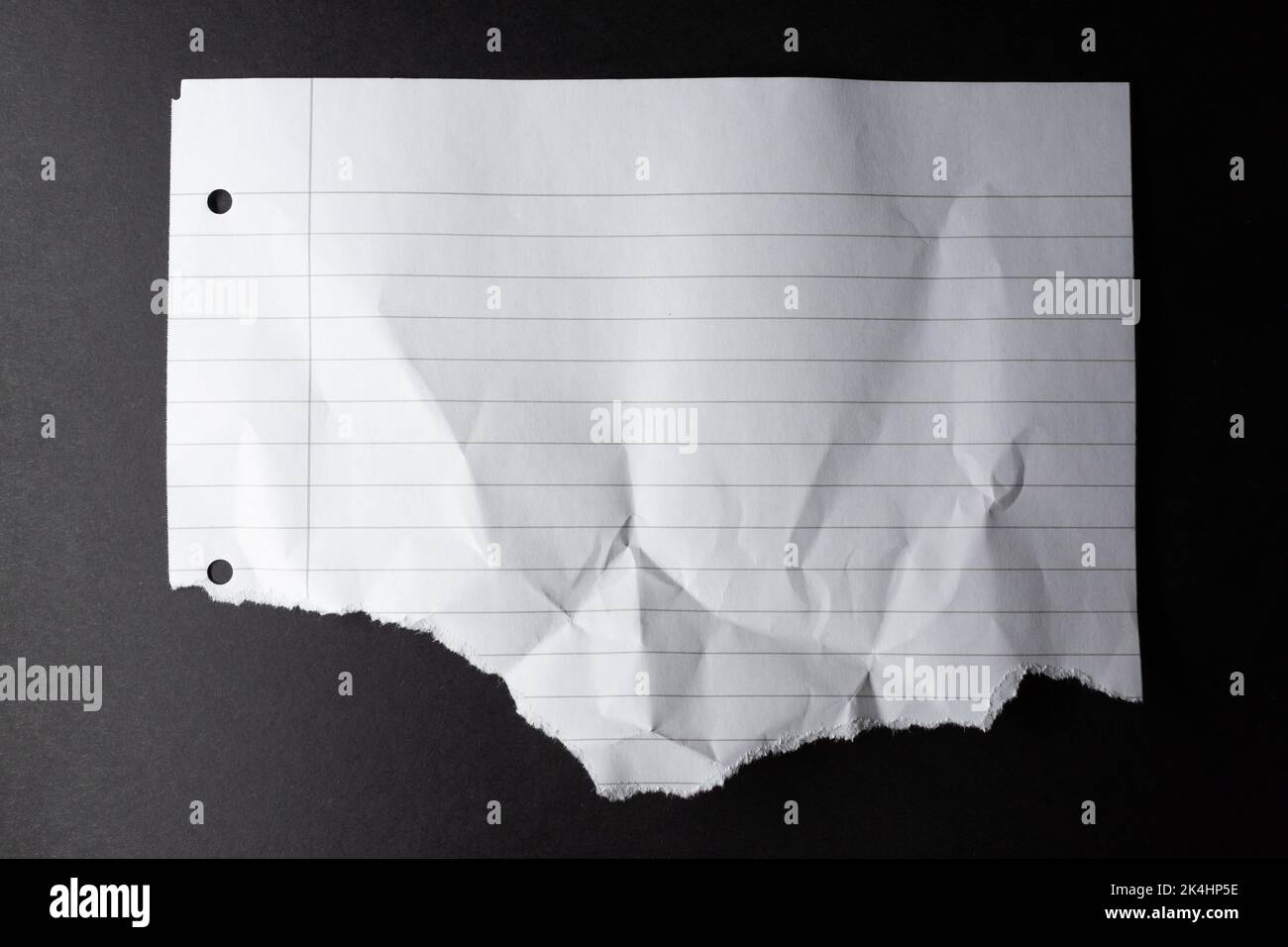 Torn scrunched up, hole punched sheet of lined white notebook paper, on ...
