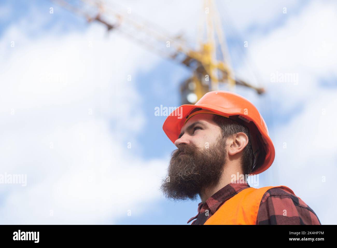Construction worker man in work clothes and a construction helmet ...