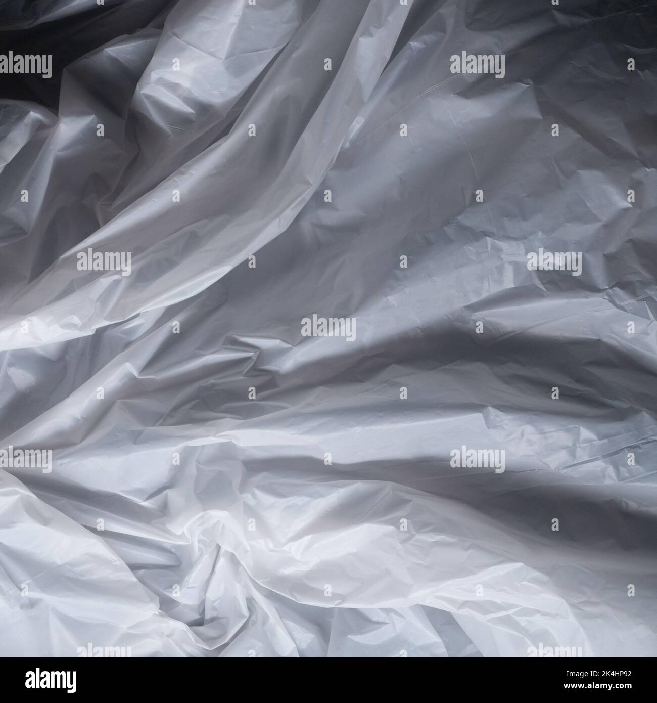 Reflecting light and shadow on creases and folds in scrunched white ...