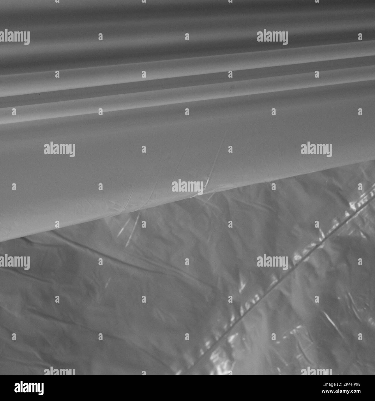 Reflecting light and shadow on creases and folds in stretched plastic ...