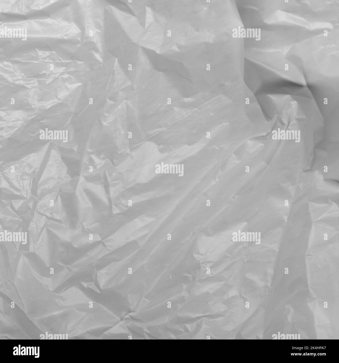 Reflected light and shadow on creases and folds in white plastic ...