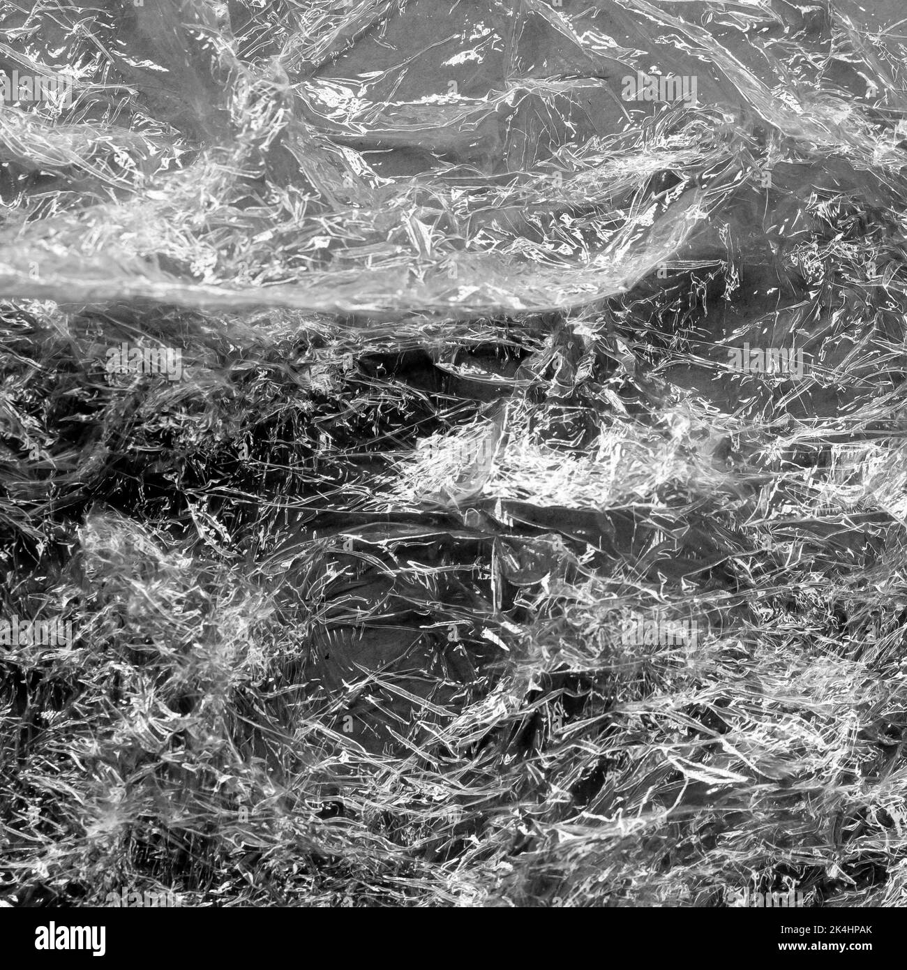 Reflecting light and shadow on creases and folds in scrunched clear ...