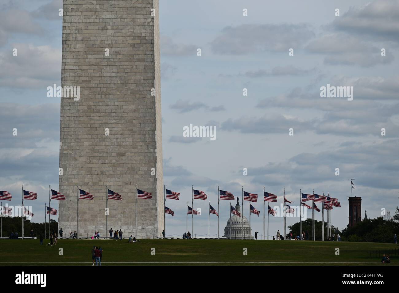 The base of the Washington Monument with the US Capitol building in the ...
