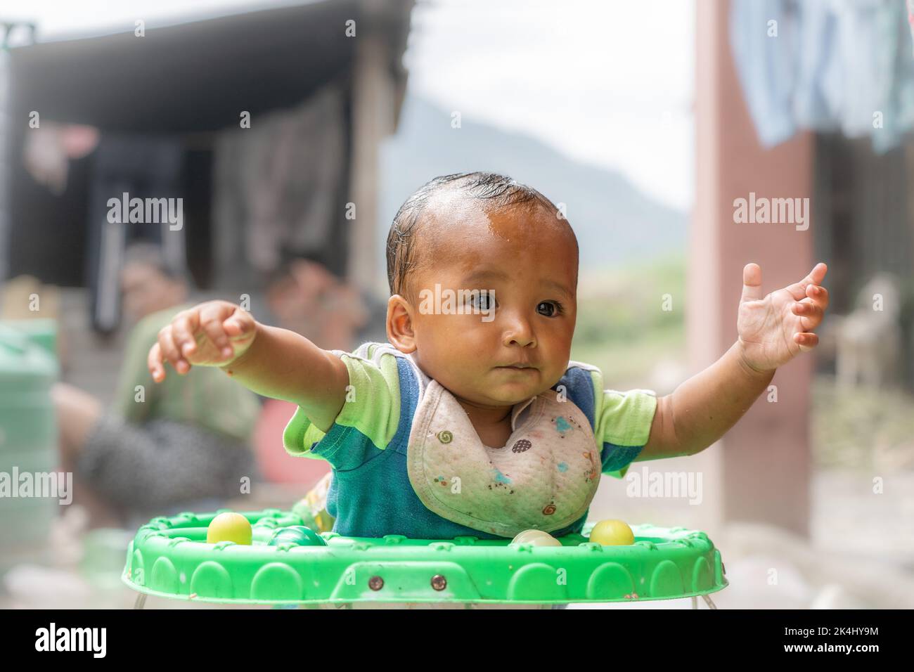 Kathmandu, Nepal - September 18, 2022: A baby Asian boy in a walker ...