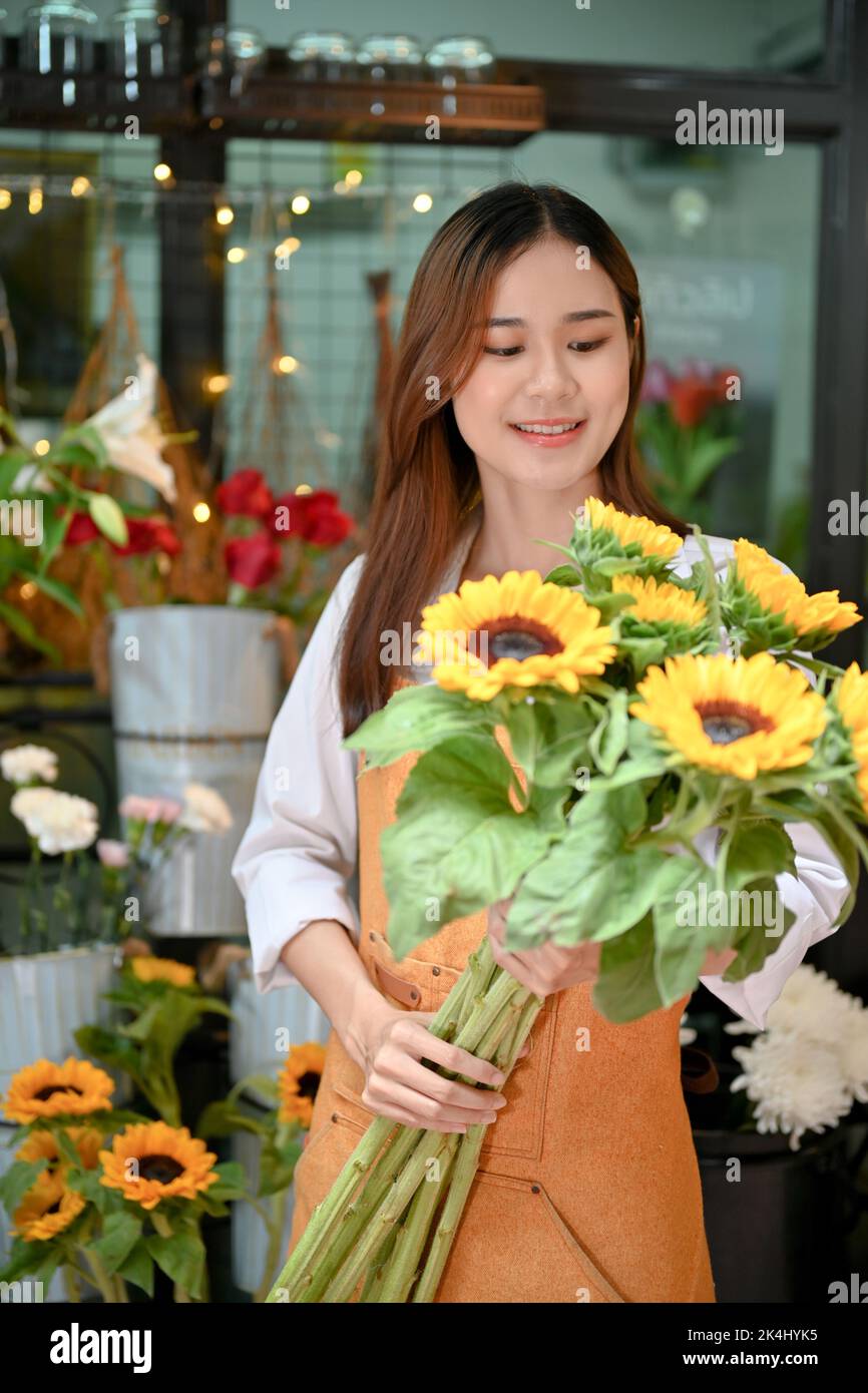 Portrait, Attractive and pretty young Asian female florist or floral ...