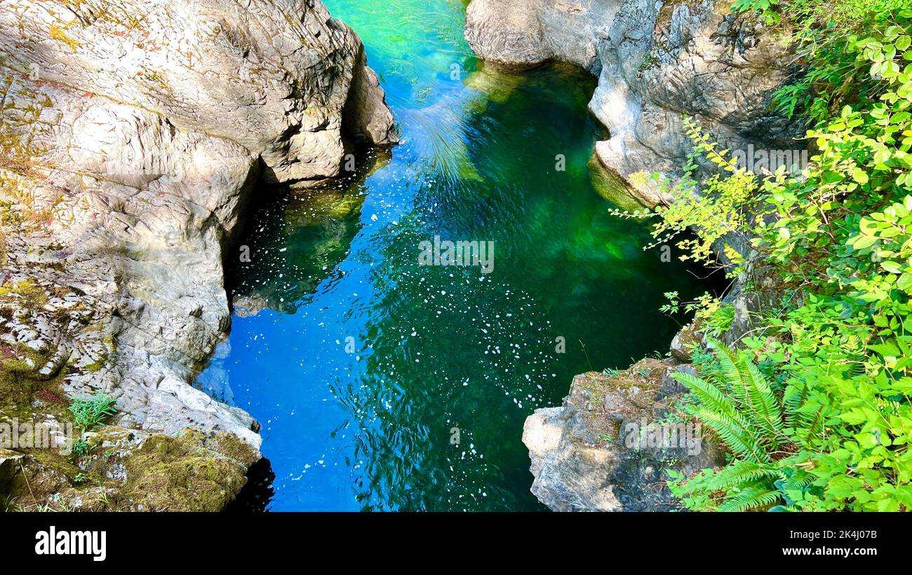 You can see a bright blue river that flows from a beautiful waterfall ...