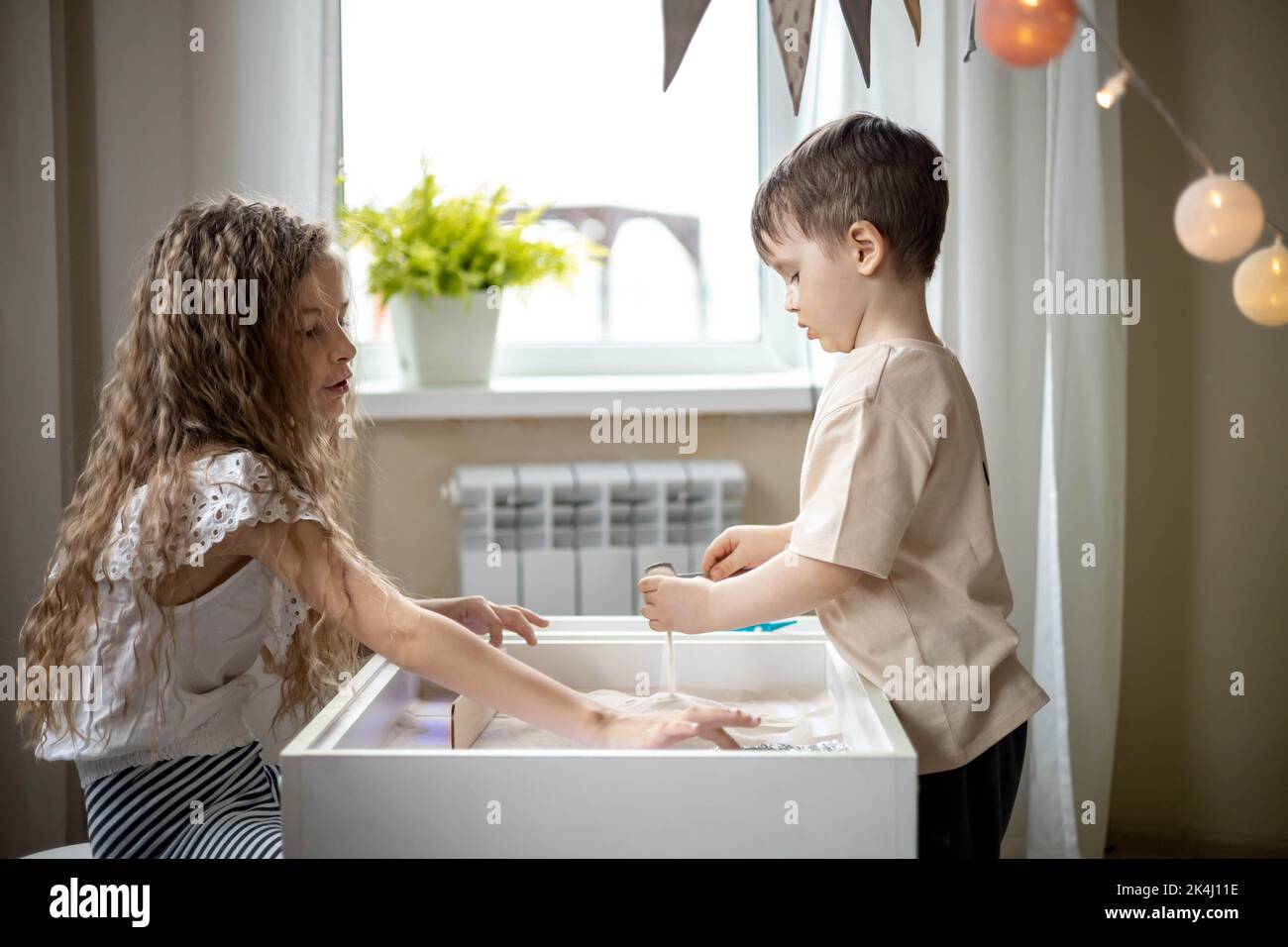 Confident children girl and boy playing sensory sand box early ...