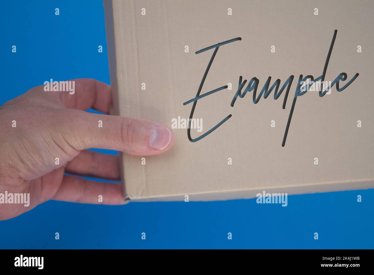 Example word with cardboard box. Brown folded card box Stock Photo - Alamy