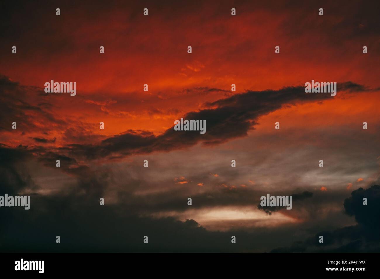 A hellish scenery of abstract clouds in the crimson sky Stock Photo - Alamy