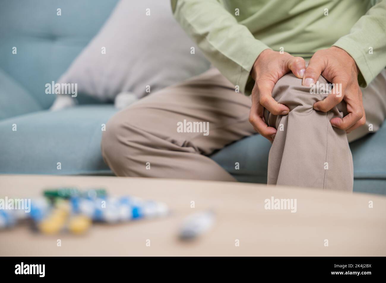 Old age. Asian senior man retirement knee joint pain on sofa, Elderly ...