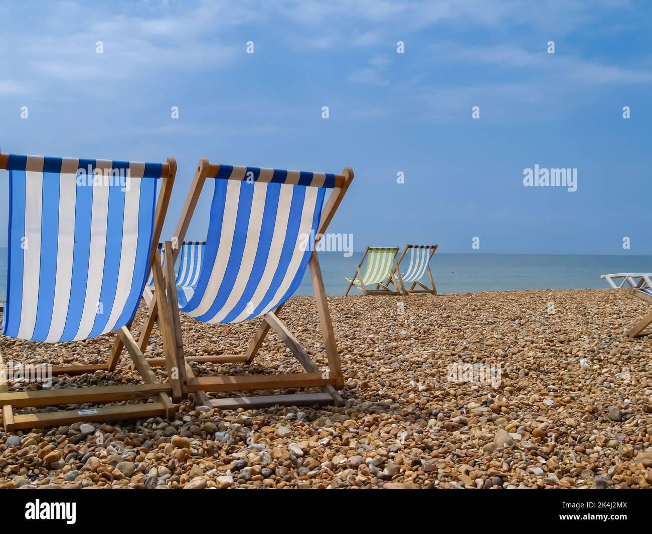 Brighton Beach and characteristic striped beach chairs in blue or red ...
