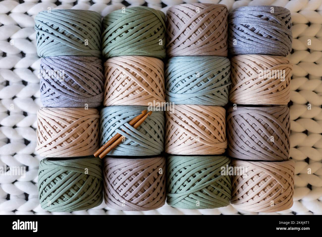 Top view pile of multicolored ribbon yarn hank reels neatly assembling ...