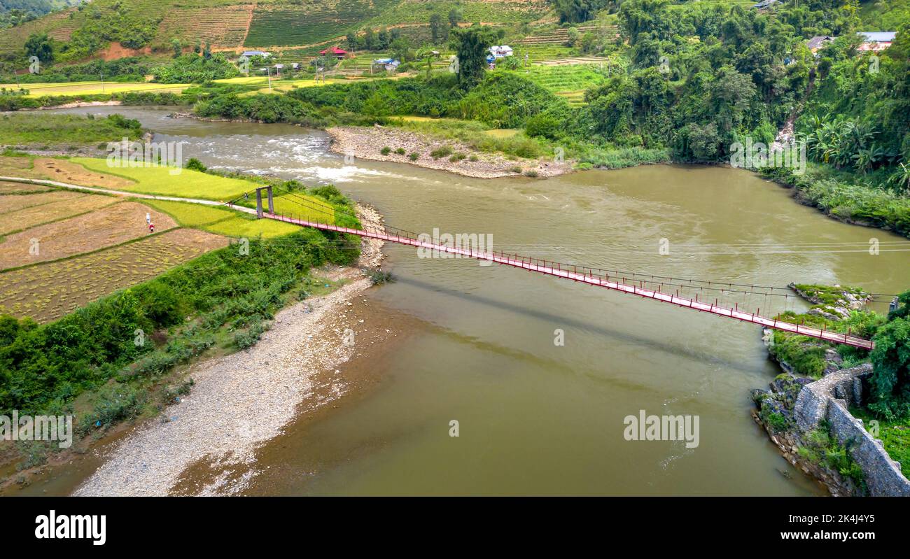 A suspension bridge over a stream in Lai Chau province in the northwest ...