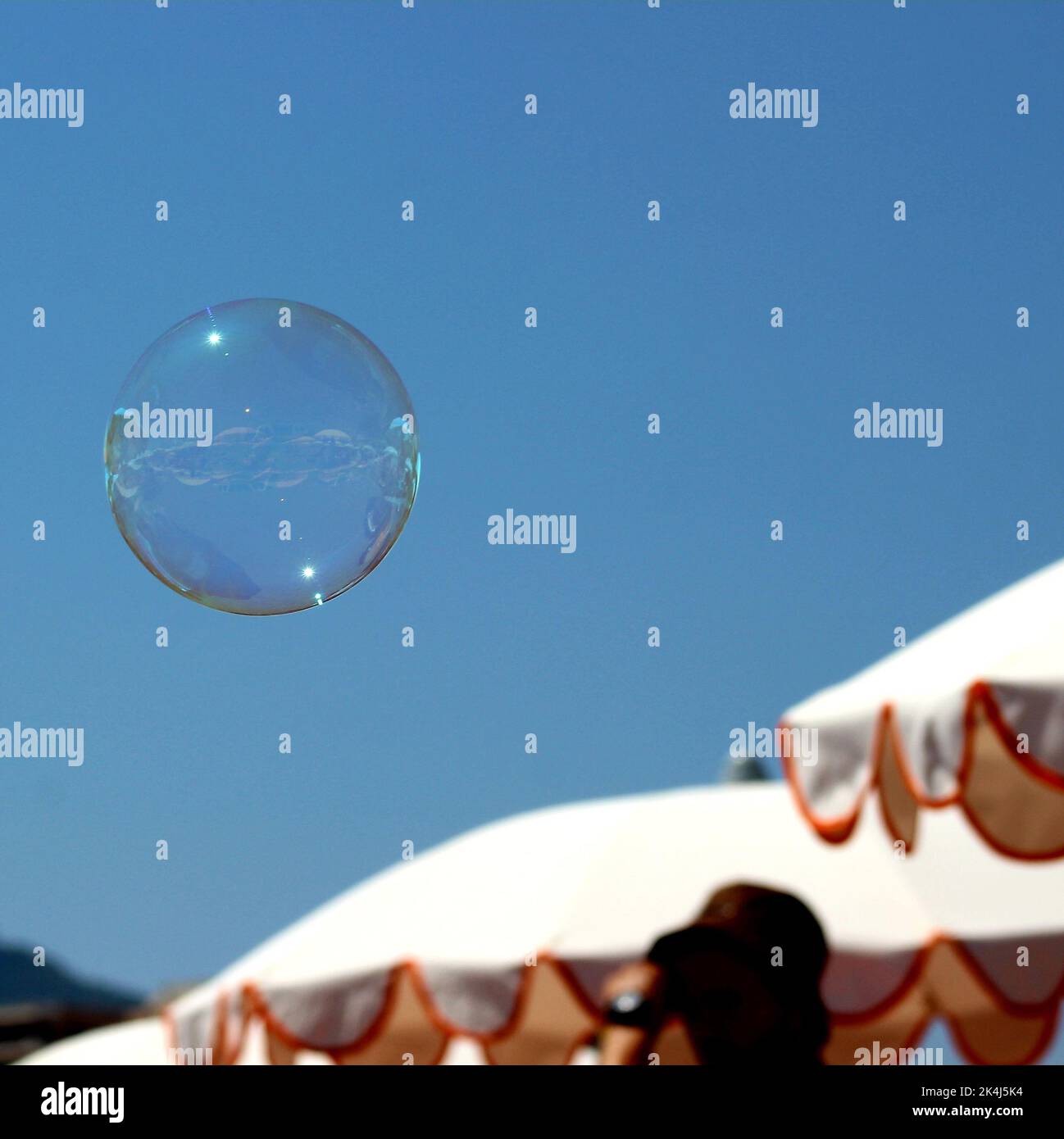 Bubble floating against blue background hi-res stock photography and ...