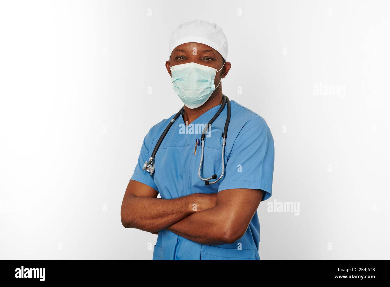 Black surgeon doctor man in blue coat white cap and surgeon mask with ...