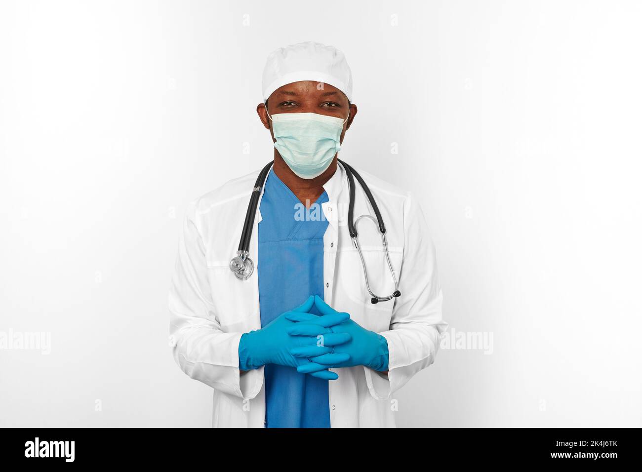 Black surgeon doctor man in blue white coat blue gloves white cap and ...