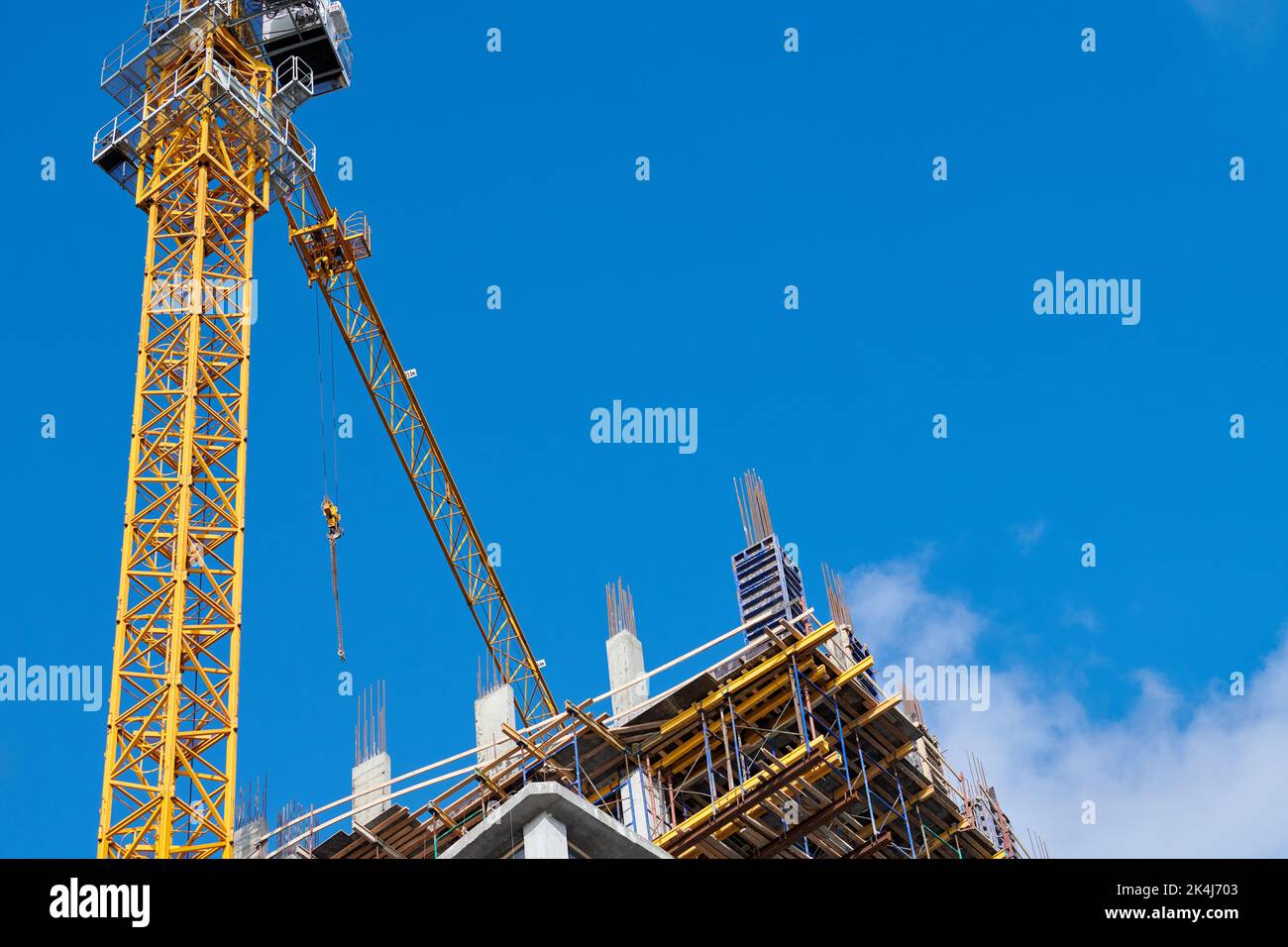 Construction of new building with reinforced concrete floors, blue sky ...