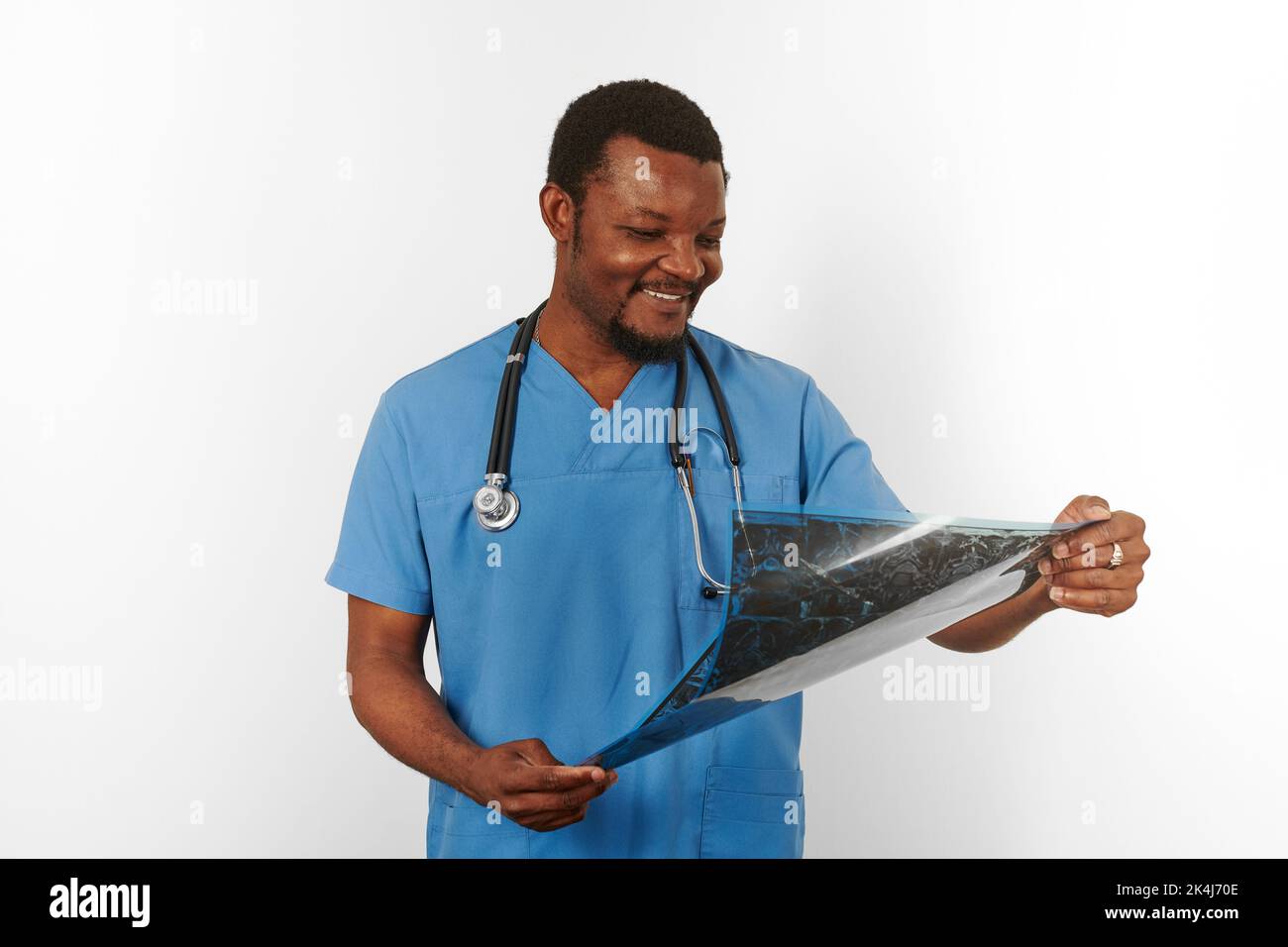 Smiling black surgeon doctor bearded man in blue coat with stethoscope ...