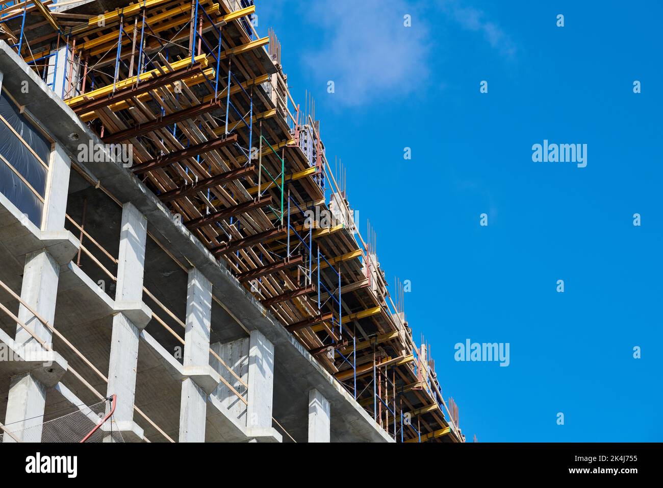 Construction of new building with reinforced concrete floors, blue sky ...