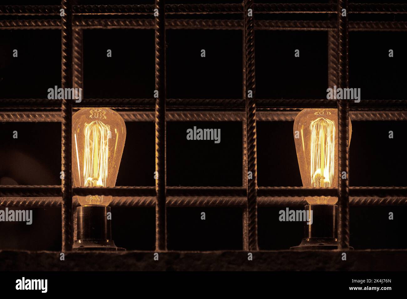 Two decorative incandescent light bulbs inside loft partition from ...