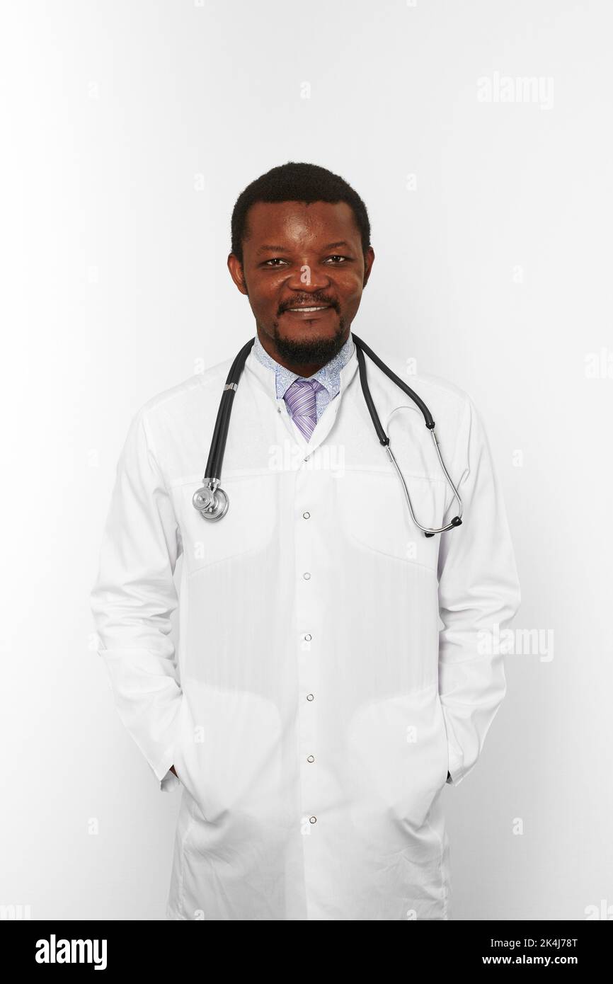 Smiling black bearded doctor man in white coat with stethoscope ...