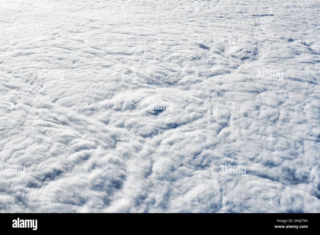 Breathtaking over clouds view from aircraft window, thick white blue ...