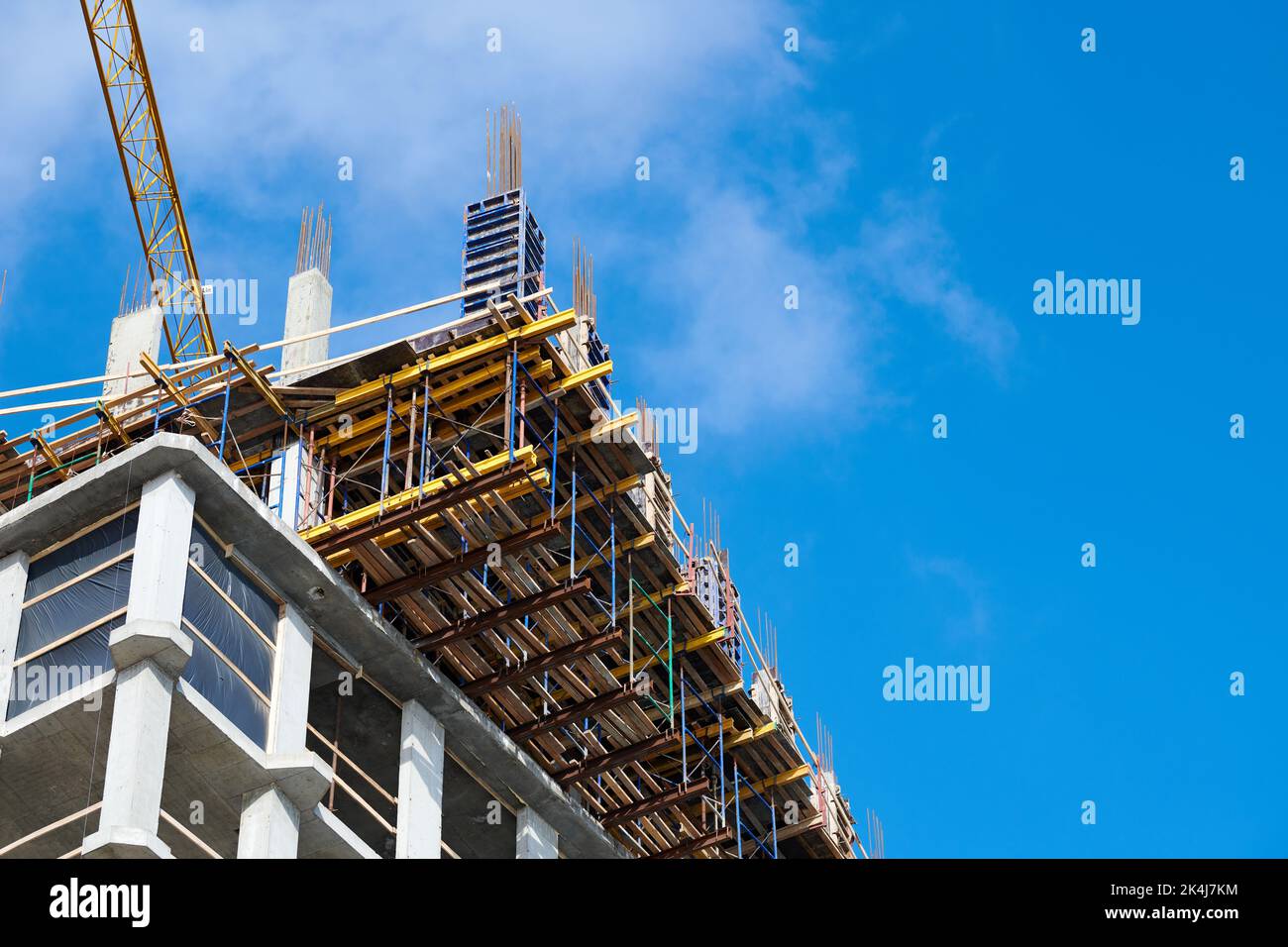 Construction of new building with reinforced concrete floors, blue sky ...