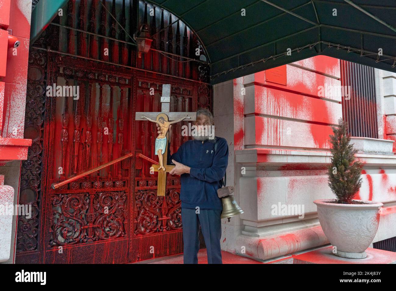 Nikoli armed with a cross and a bell protest in front of the defaced ...