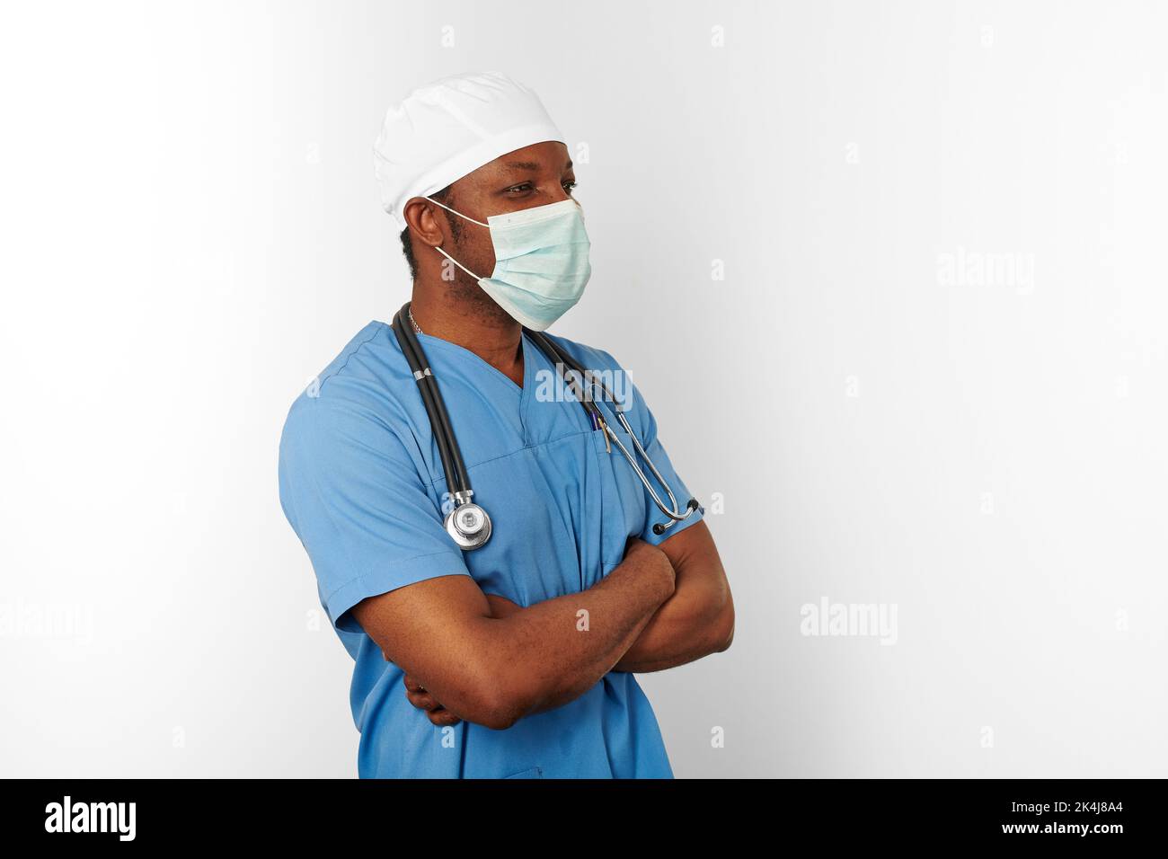 Black surgeon doctor man in blue coat white cap and surgeon mask with ...