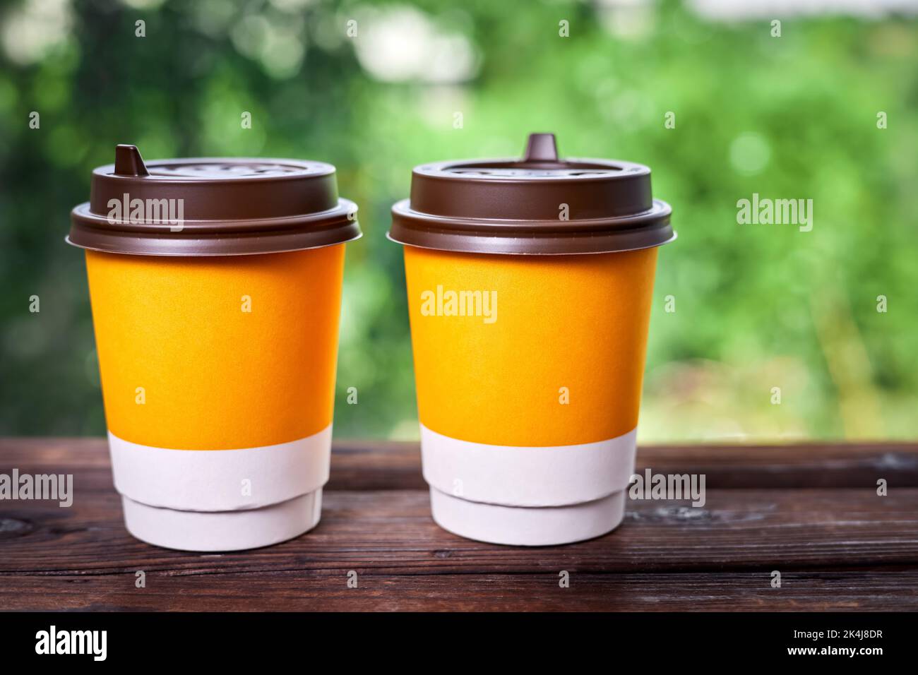 Takeaway cups for drink on a wooden surface against the background of ...