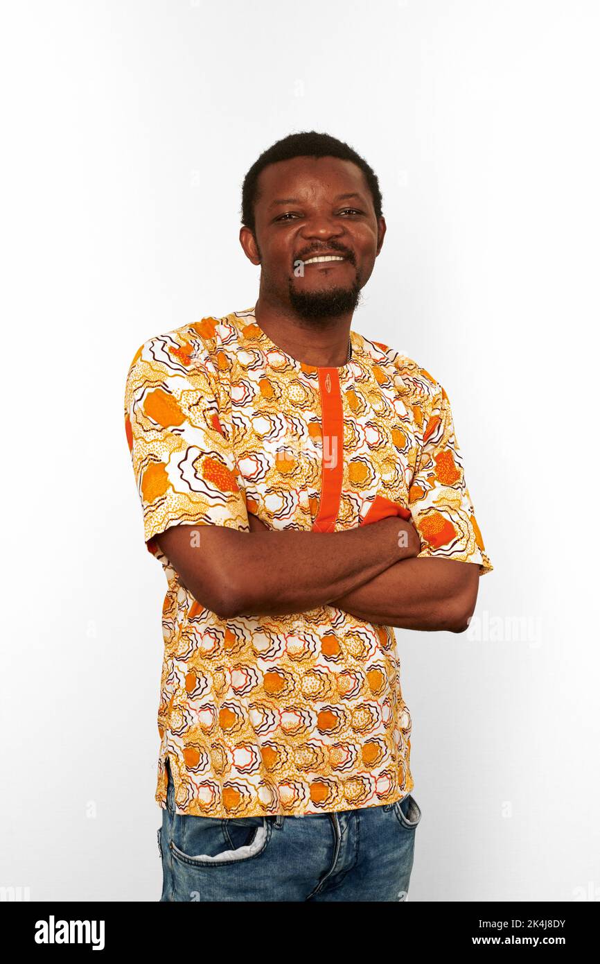 Smiling black man with crossed arms in African bright clothes isolated ...
