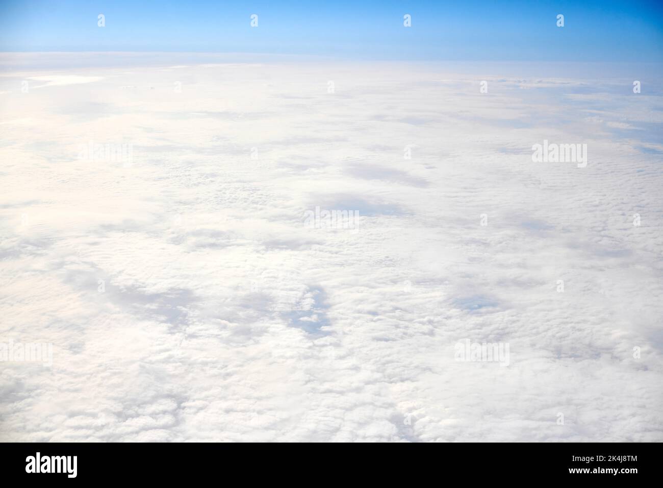 Breathtaking over clouds view from aircraft window, thick white blue ...