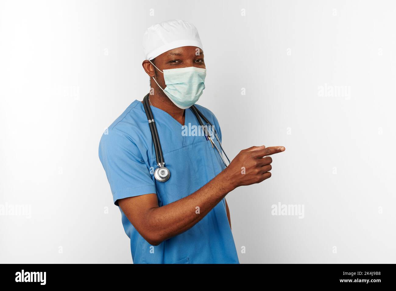 Black surgeon doctor man in blue coat white cap and surgeon mask ...