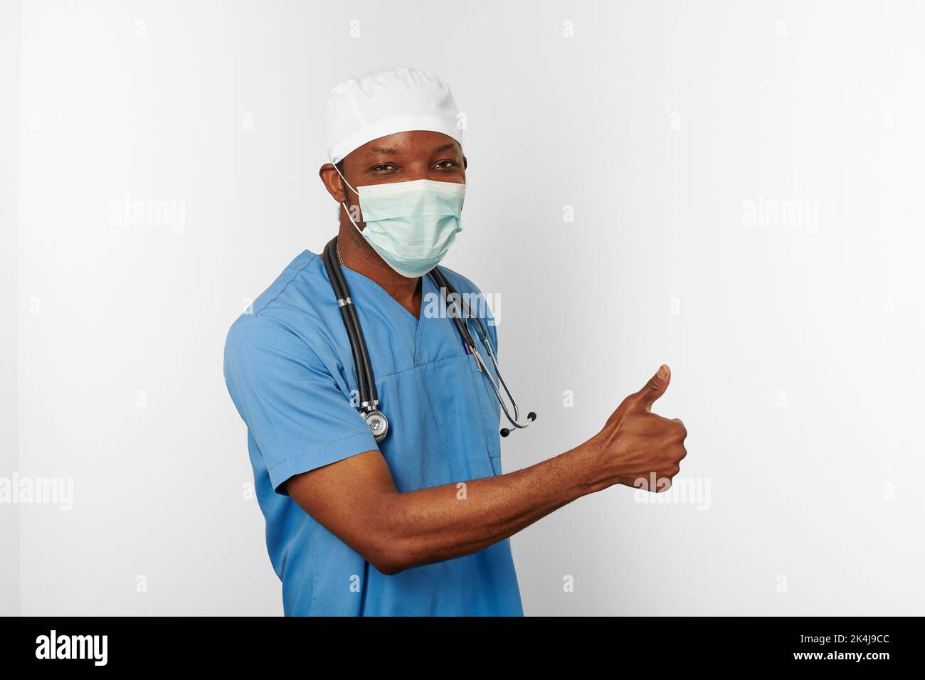 Black surgeon doctor man in blue coat white cap and surgeon mask with ...