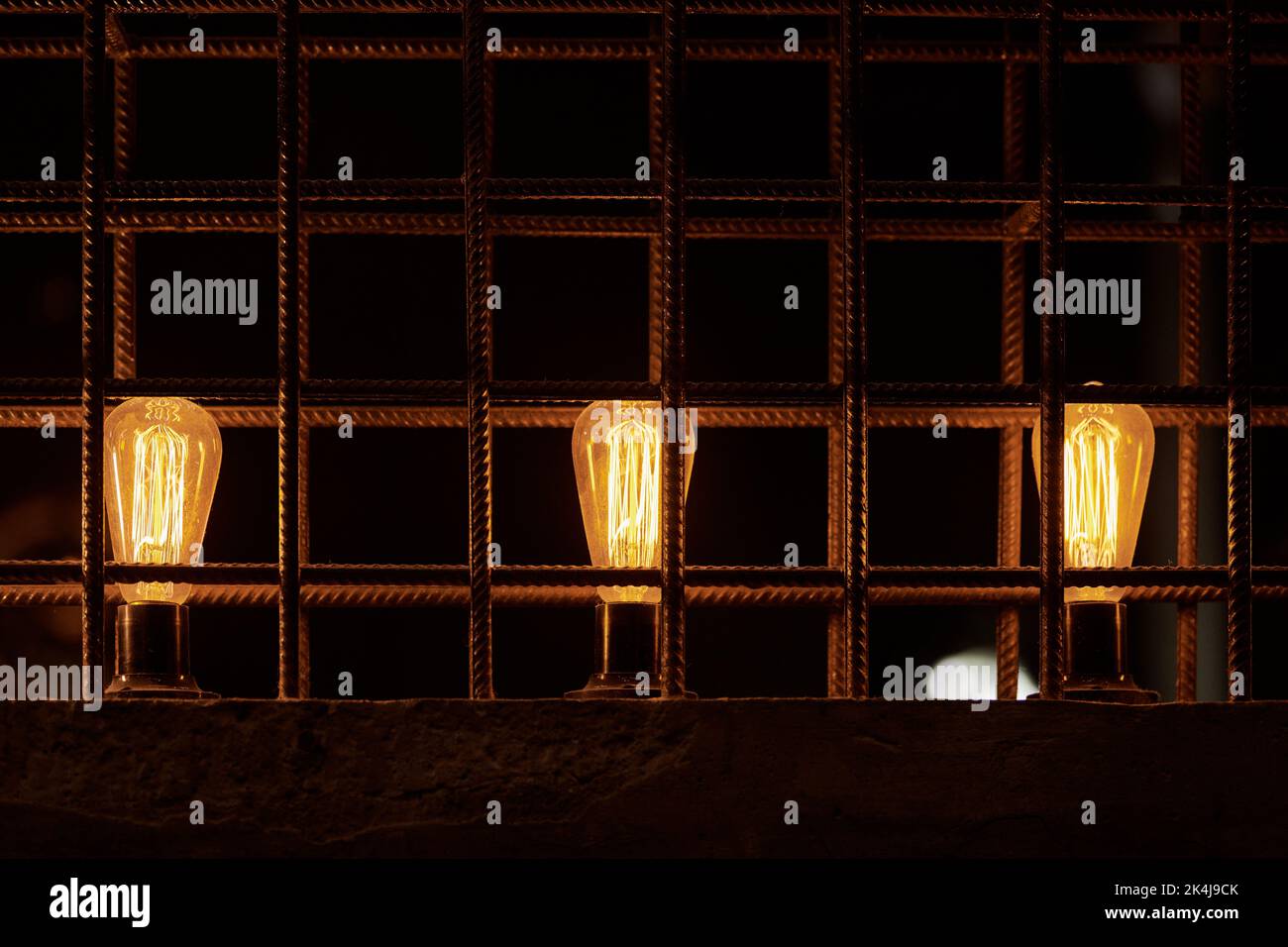 Three decorative incandescent light bulbs inside loft partition from ...