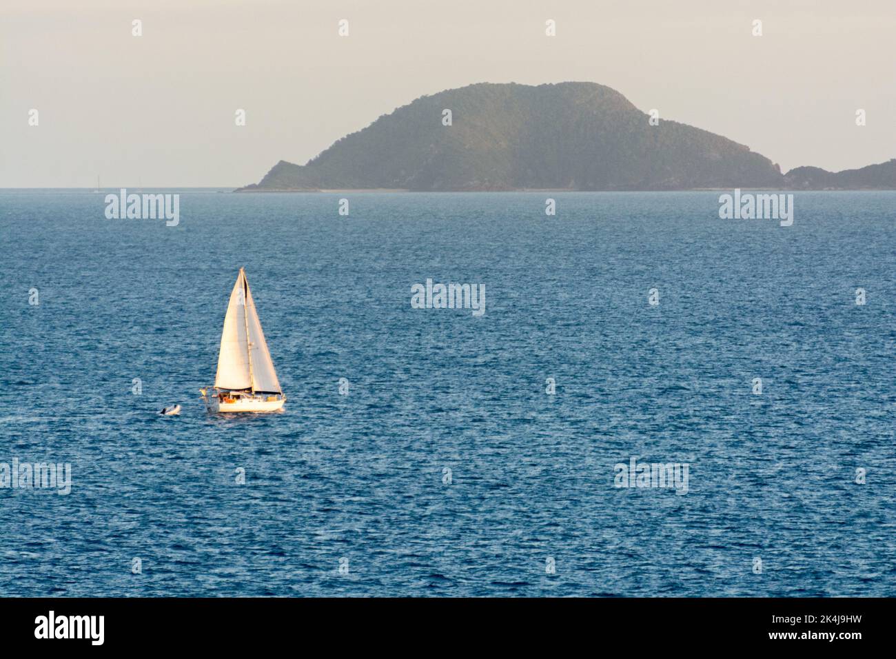 sailing yacht (sloop) at sunrise off airlie beach in the whitsunday ...