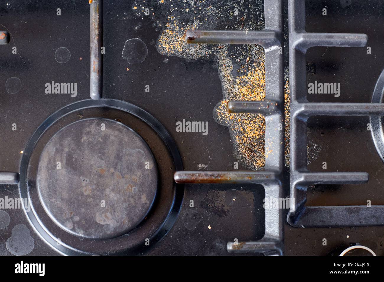 Dirty unclean kitchen black stove with dried food spots, fat stains and ...