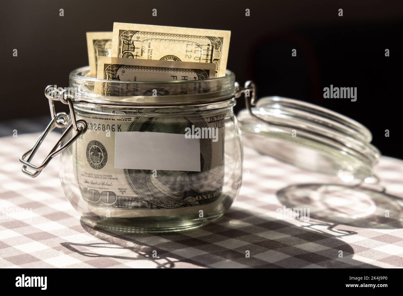 Dollar banknote saving money in glass jar. Consumption and economy ...